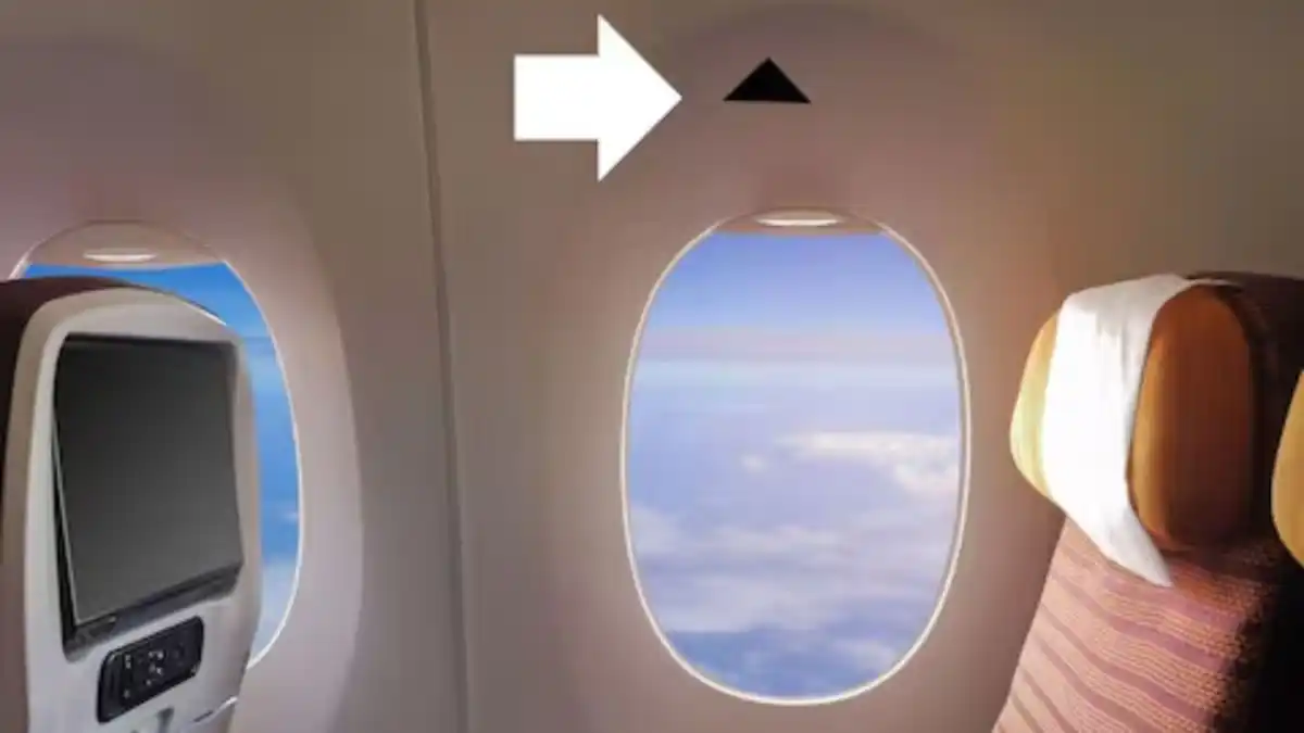 The Hidden Meaning Behind Triangle Symbols Above Airplane Windows ...